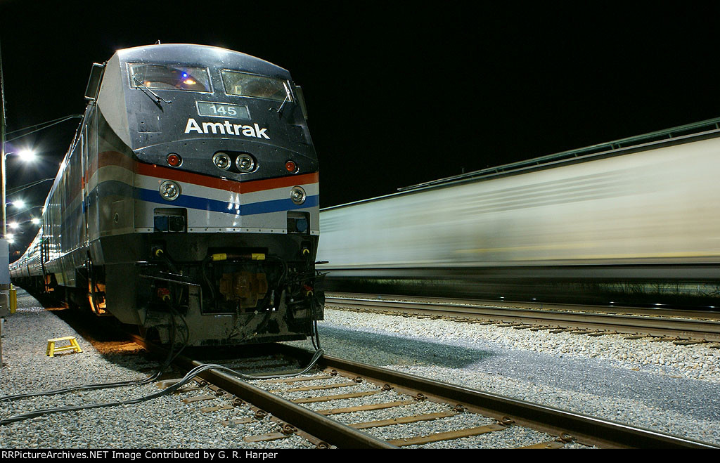 Amtrak 145 and train on storage track and a moving NS train P97 on #2 Main